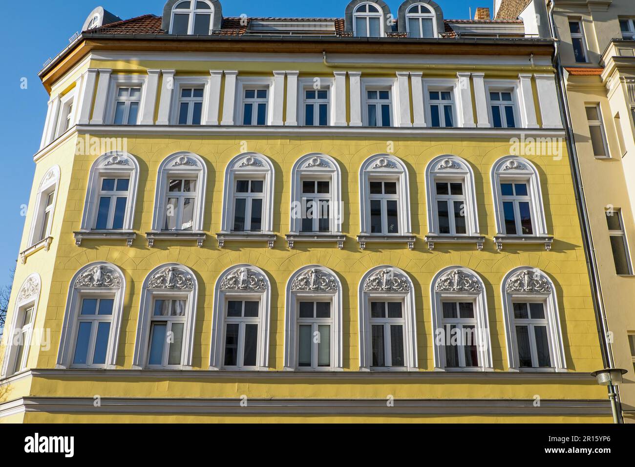 Yellow renovated old building in Berlin Stock Photo - Alamy