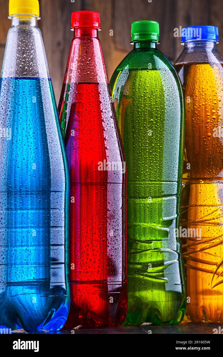 Plastic bottles of assorted carbonated soft drinks in variety of colors ...