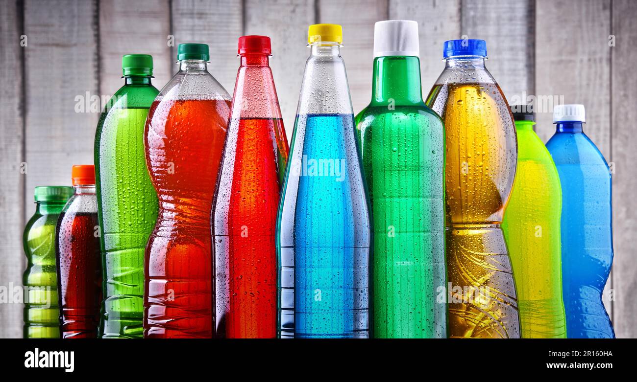 Plastic bottles of assorted carbonated soft drinks in variety of colors ...