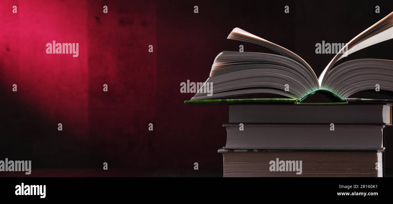Composition with open book on the table Stock Photo - Alamy