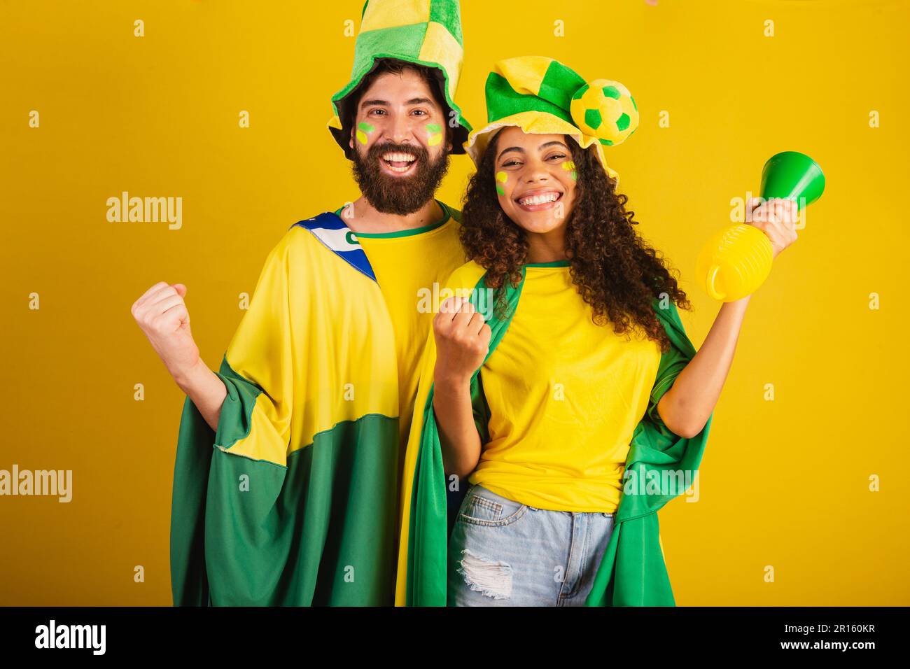 couple of brazil soccer supporters, dressed in the colors of the nation ...