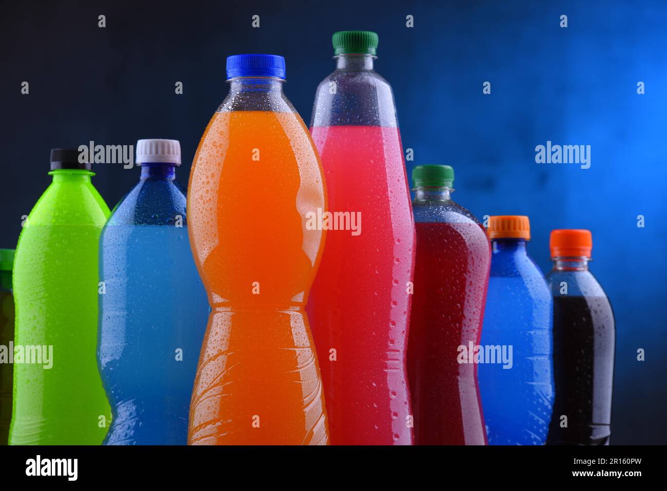 Plastic bottles of assorted carbonated soft drinks in variety of colors ...