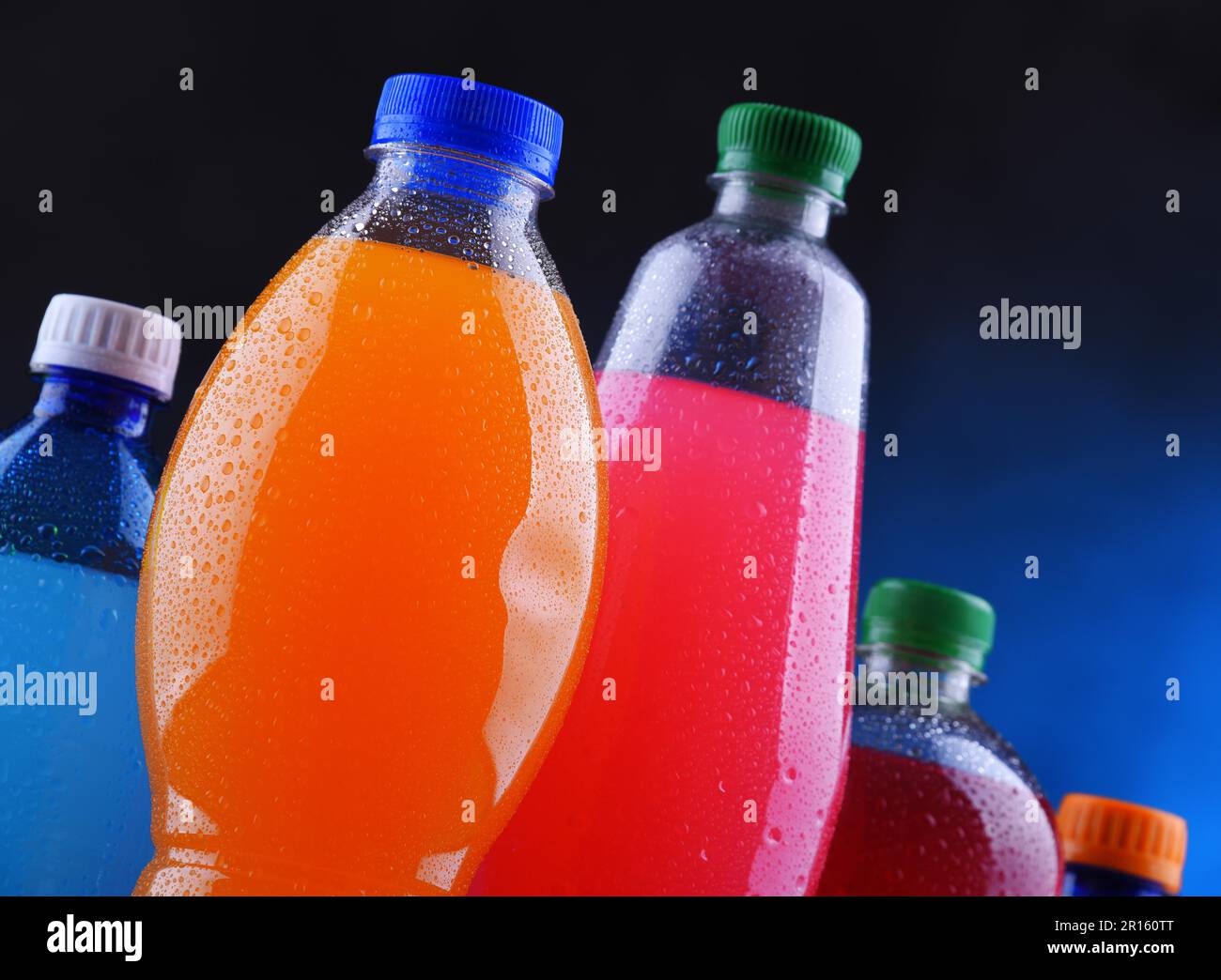 Plastic bottles of assorted carbonated soft drinks in variety of colors ...