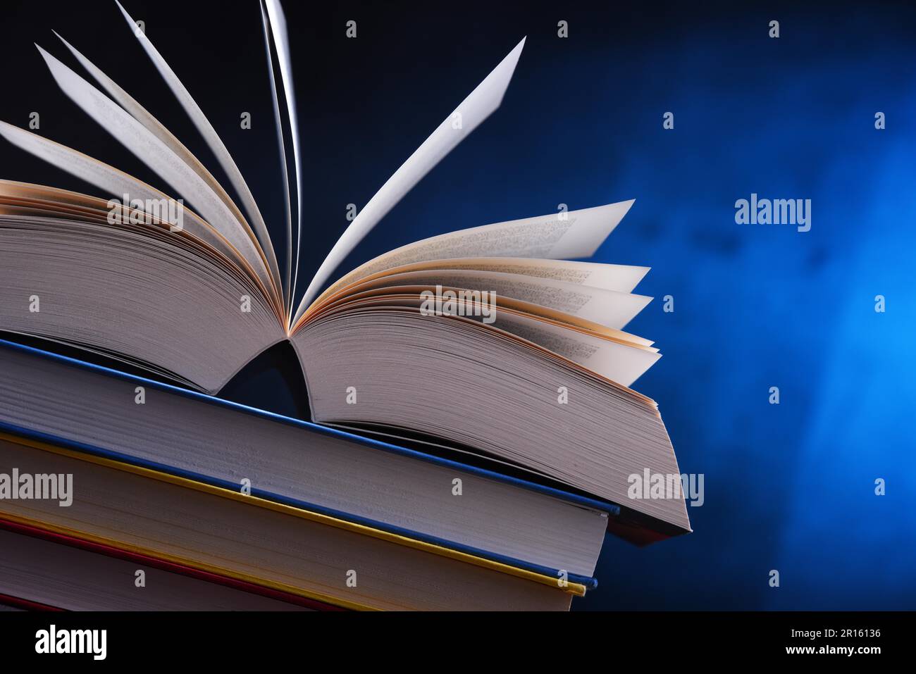 Composition with open book on the table Stock Photo - Alamy