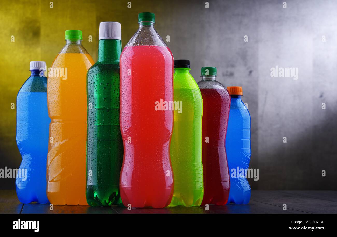 Plastic bottles of assorted carbonated soft drinks in variety of colors ...