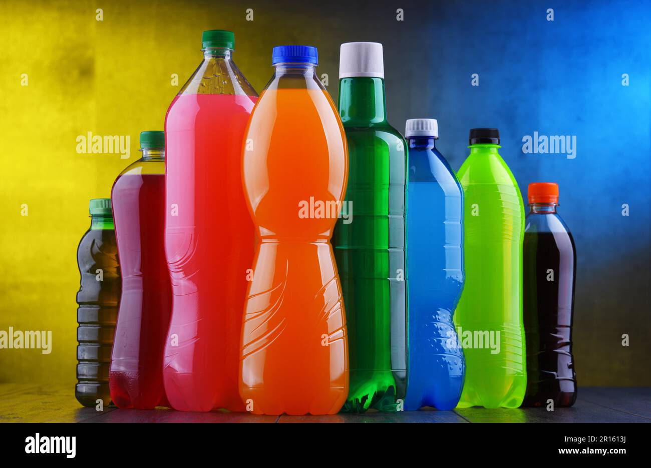 Plastic bottles of assorted carbonated soft drinks in variety of colors ...