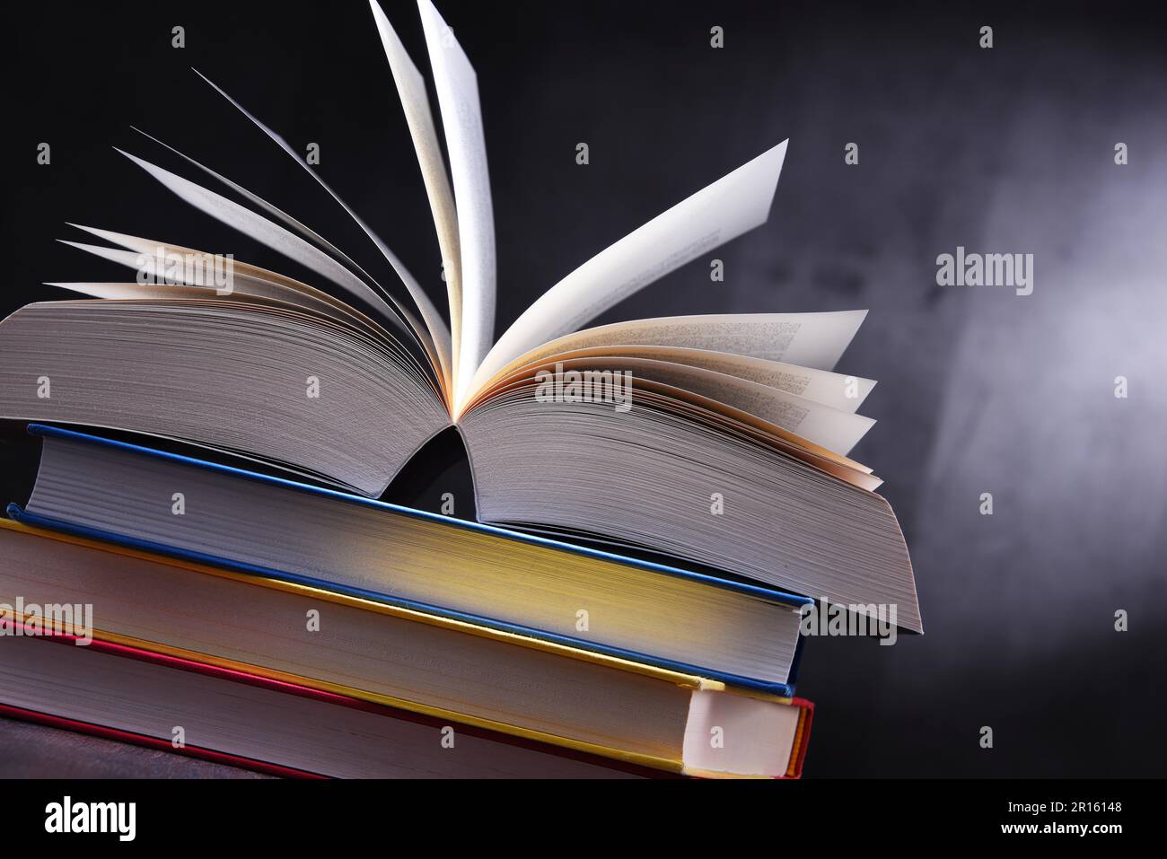 Composition with open book on the table Stock Photo - Alamy