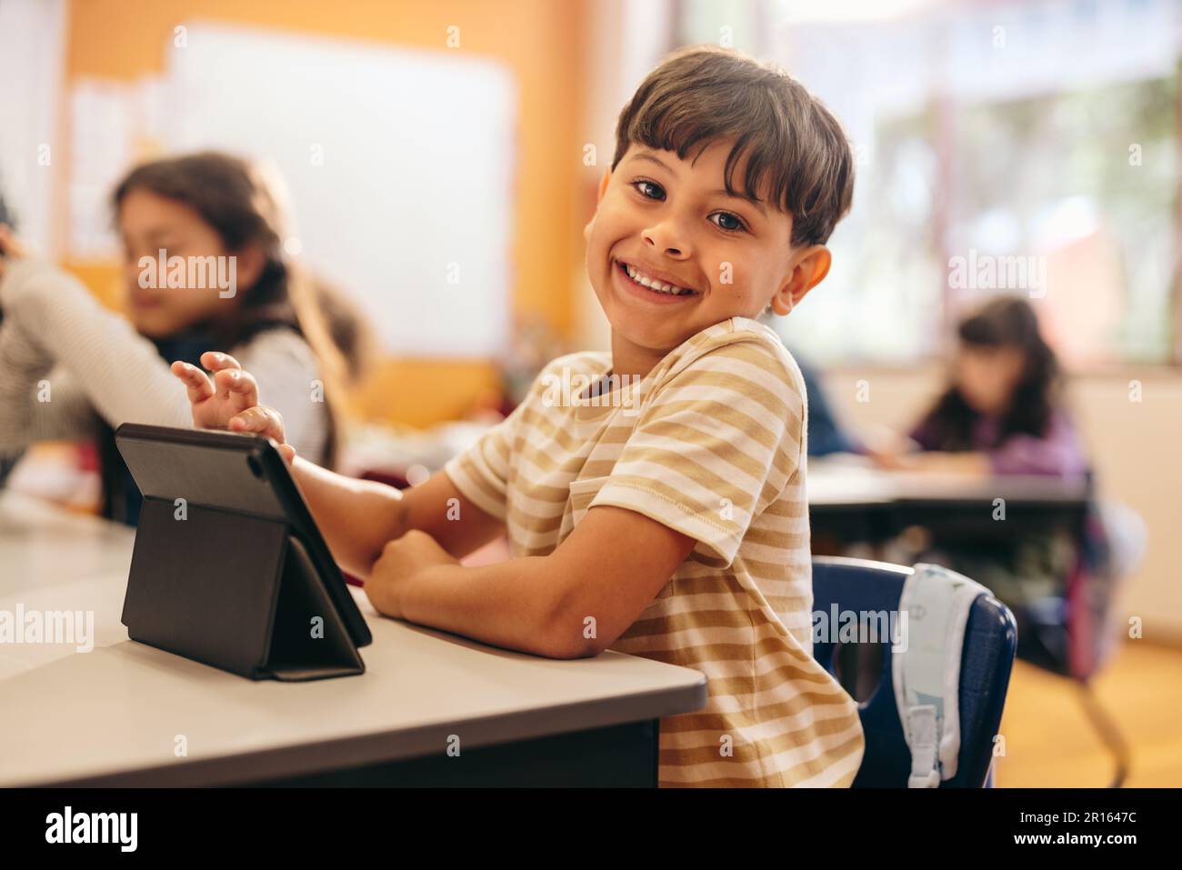 Child development in action as young kid learns to code with a tablet ...