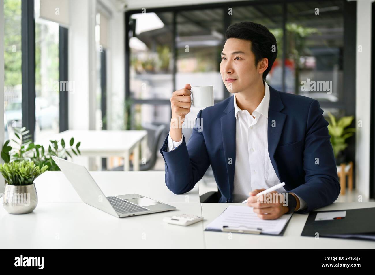 Inspired and smart millennial Asian businessman or male CEO informal ...