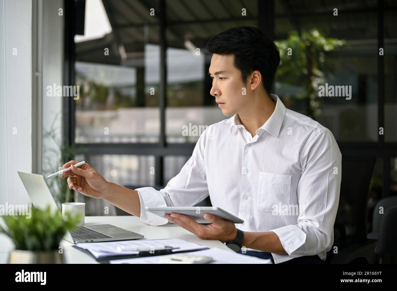 Professional and smart millennial Asian businessman or male CEO focuses ...