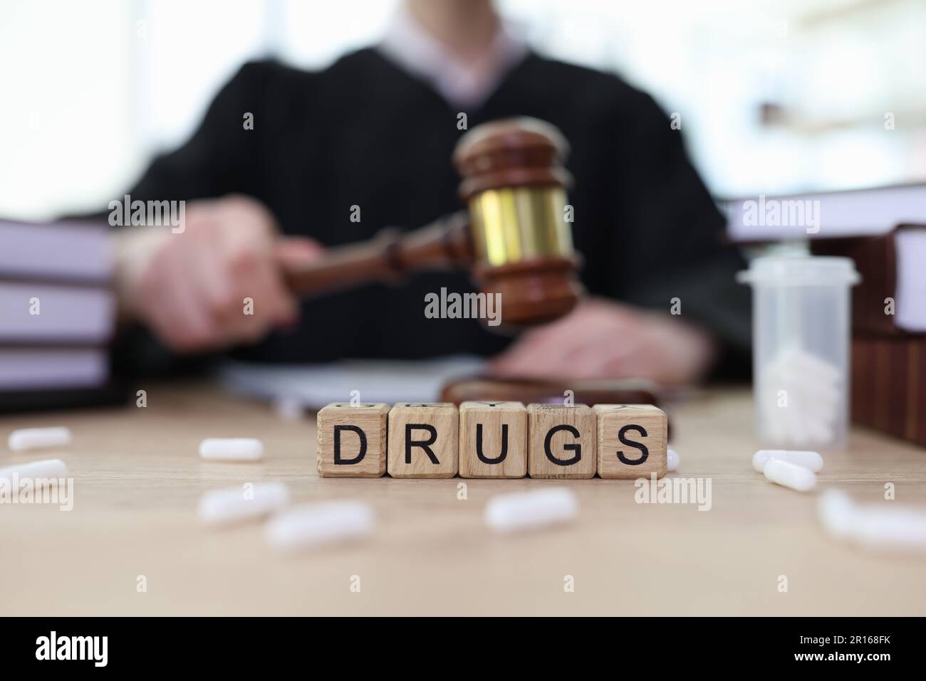 Word Drugs with cubes and scattered pills on judge counter Stock Photo ...