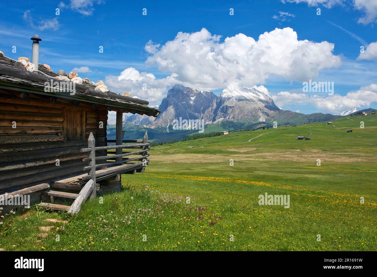 Alpine huts on the Alpe di Siusi with Sassolungo and Sassolungo ...