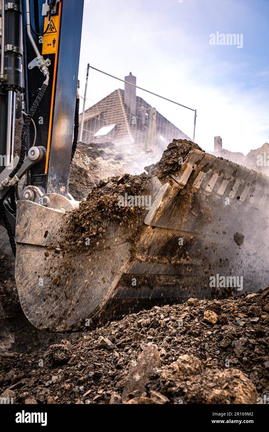 Excavator bucket of a Liebherr R922G8 with soil on construction site ...