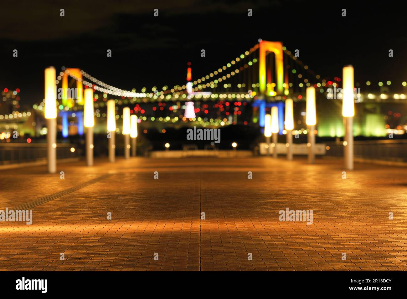 Cobbled brick and Rainbow Bridge lit-up Stock Photo - Alamy