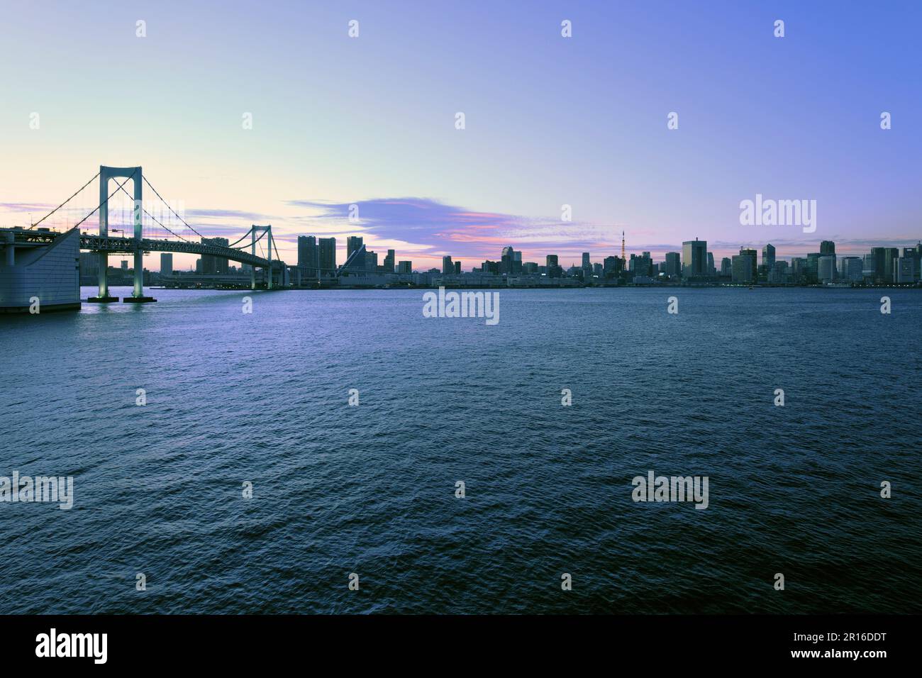 Rainbow Bridge and Tokyo port and buildings in the sunset Stock Photo ...