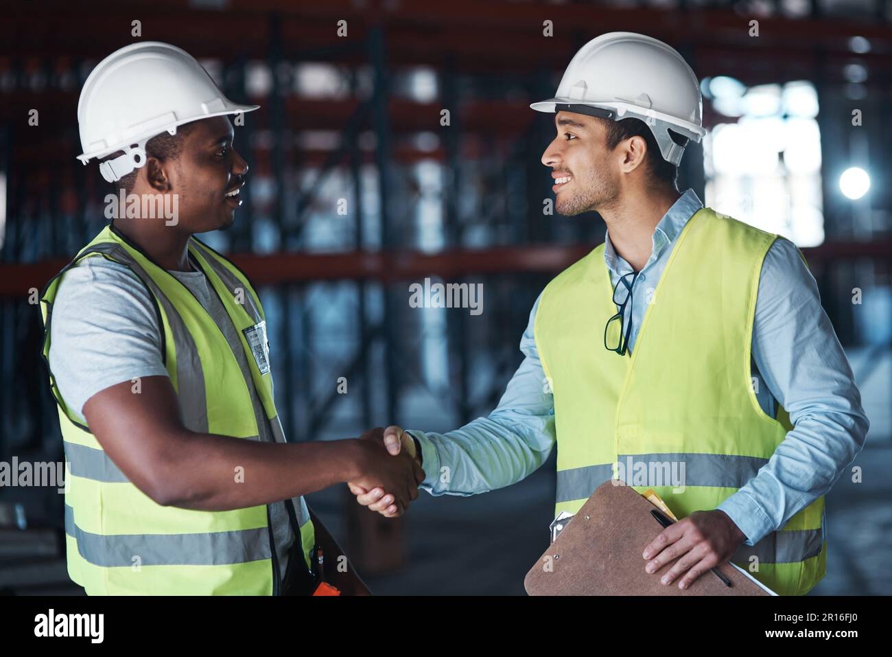 Lets go team. two young contractors standing in the warehouse together ...