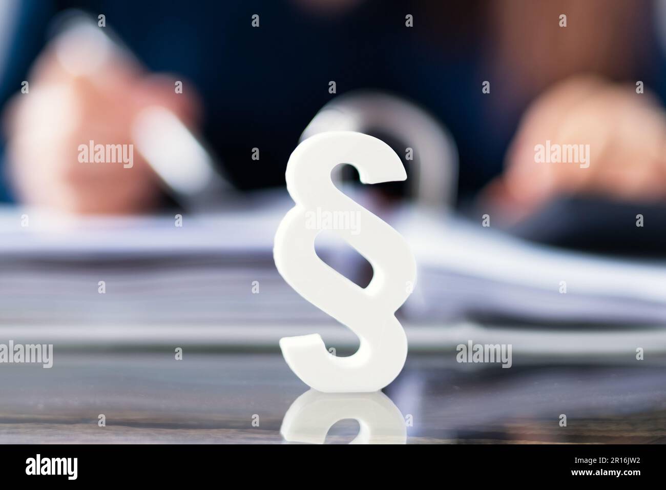 Close-up Of A Red Paragraph Symbol In Front Of Person Working At ...