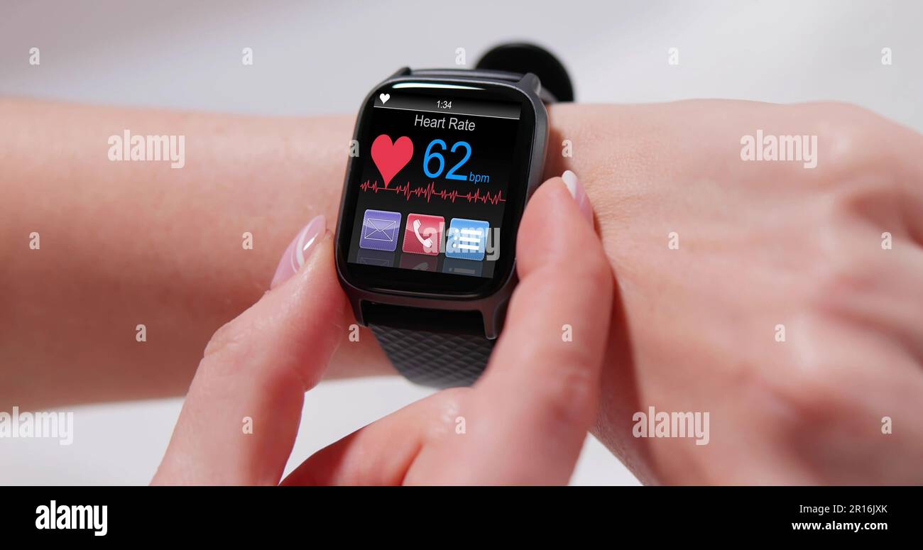 Smart Watch Showing Heartbeat Monitor On Woman's Hand Stock Photo - Alamy