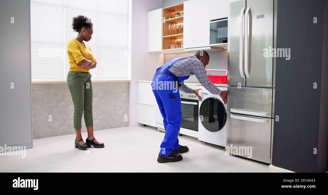 Repairman woman looking washing hi-res stock photography and images - Alamy