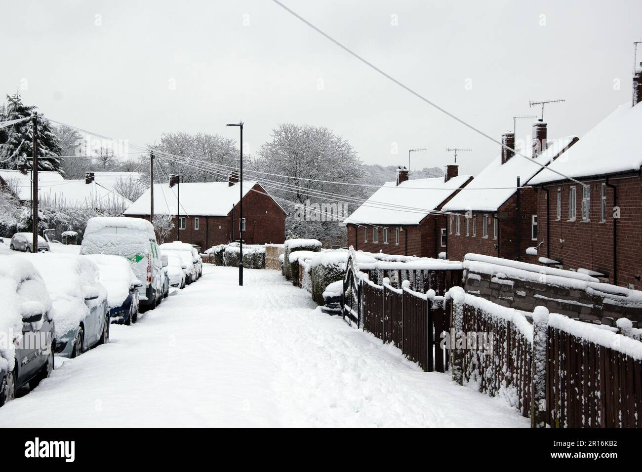 Street view fresh of snow with cars houses fences Stock Photo - Alamy