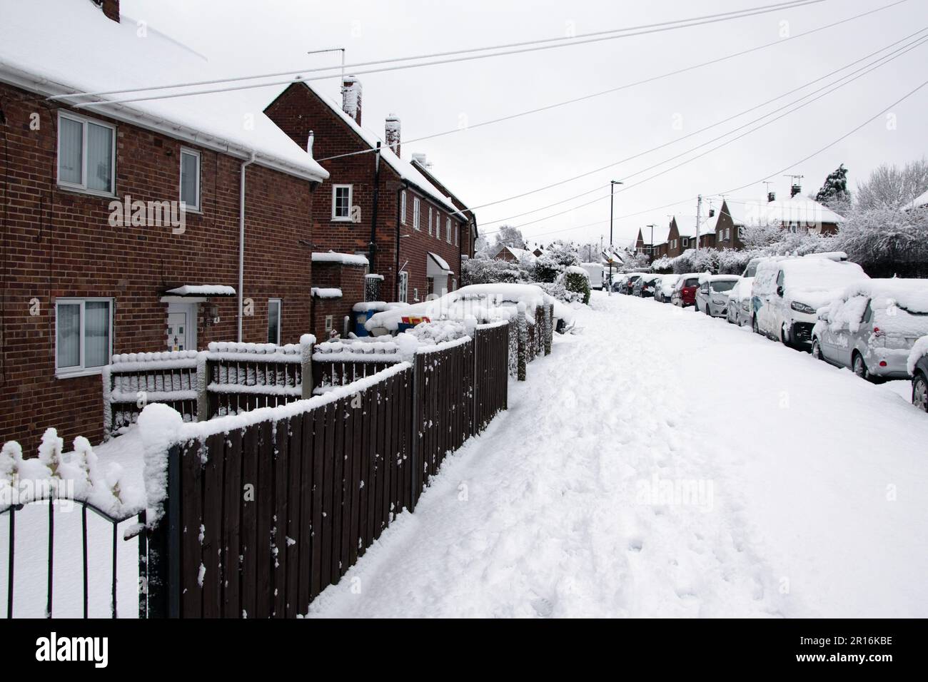 Street view fresh of snow with cars houses fences Stock Photo - Alamy