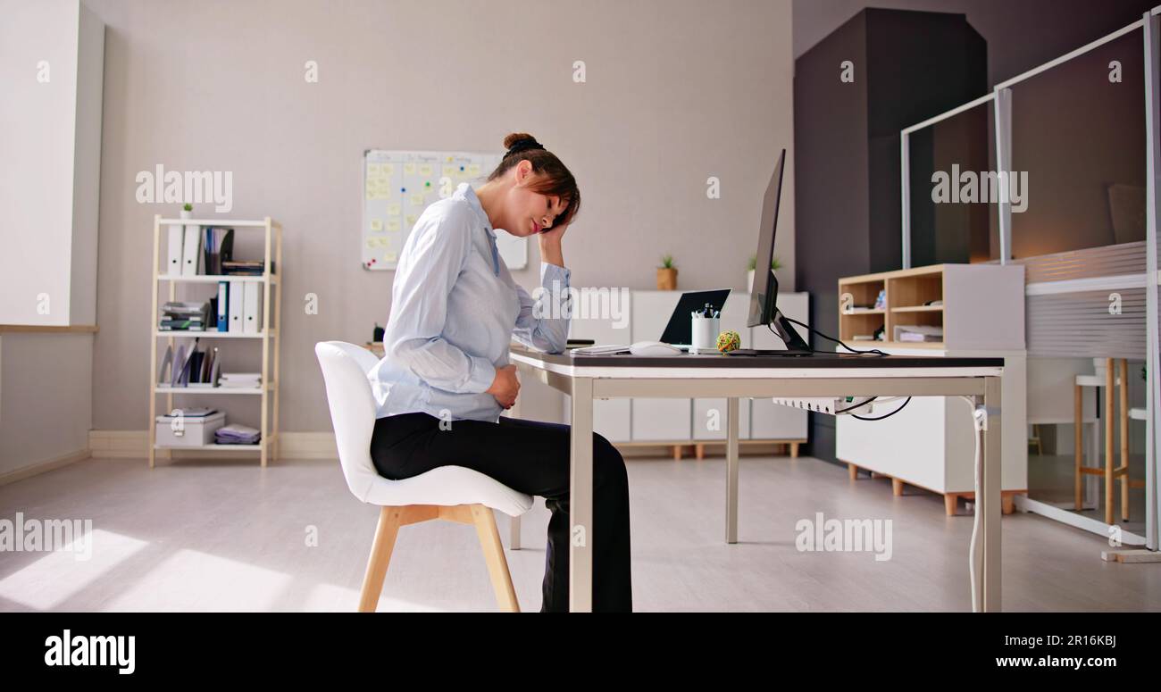 Pregnant women at work uncomfortable hi-res stock photography and ...