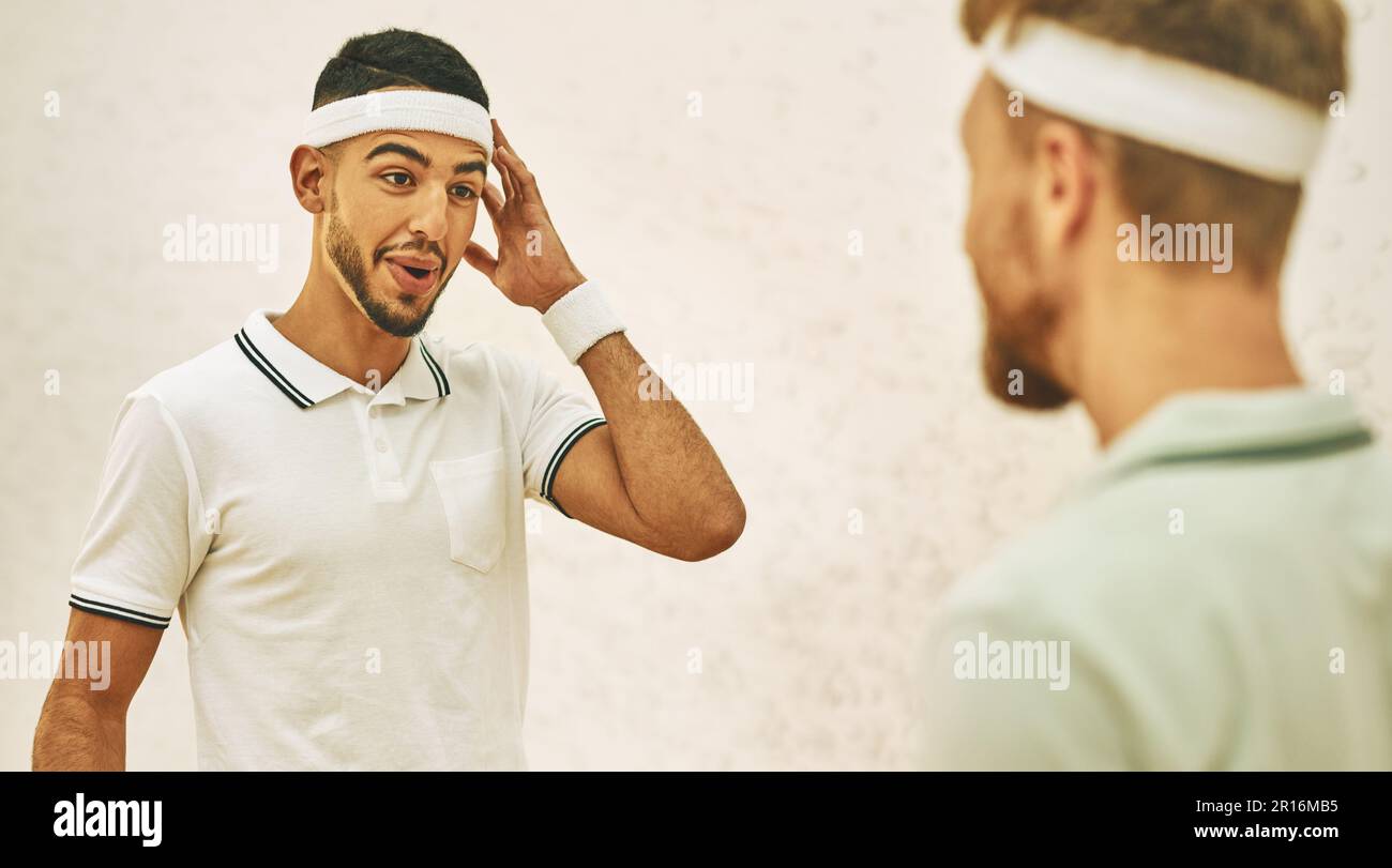 A squash buddy is the best buddy. two young men chatting after playing ...