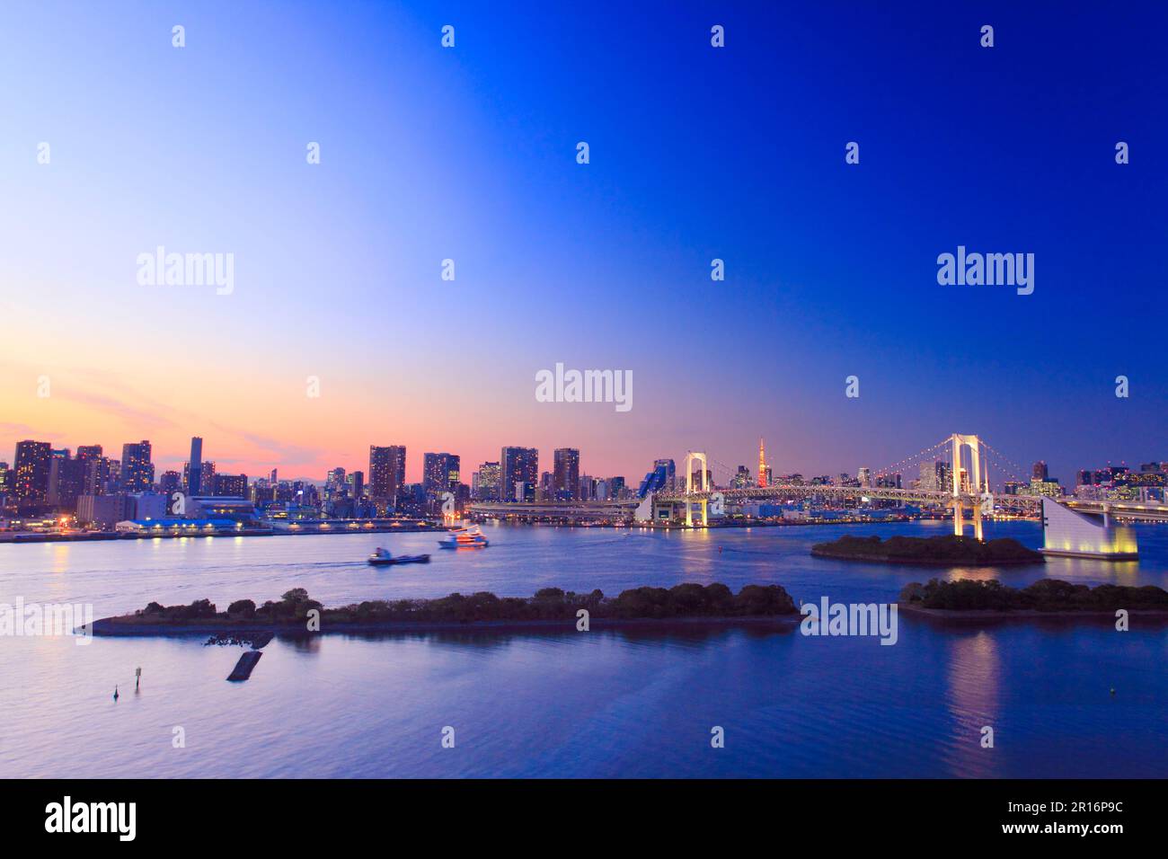 Bay Area buildings and Rainbow Bridge and ship at night Stock Photo - Alamy