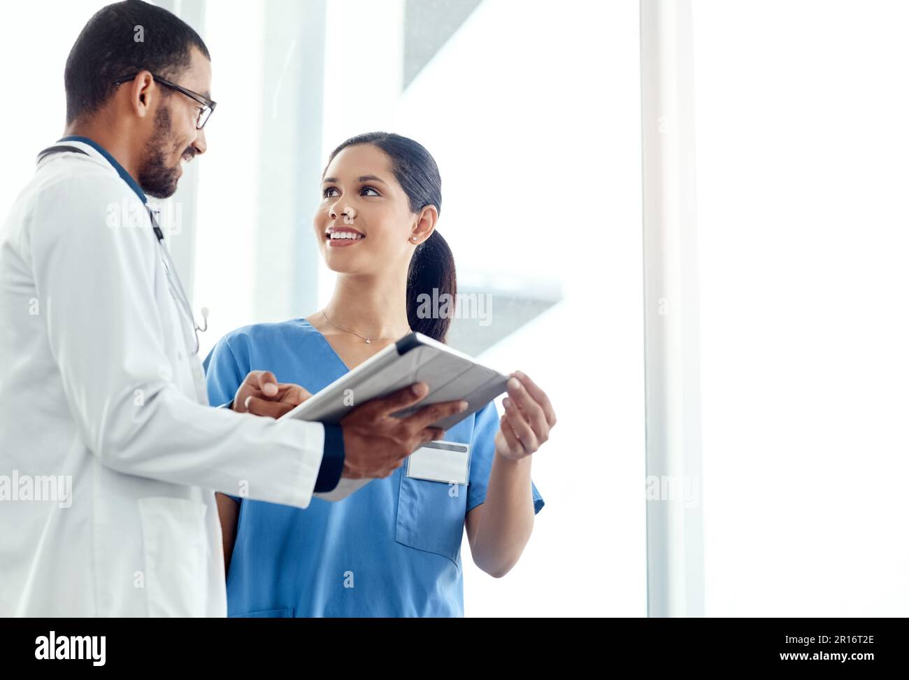 I always appreciate your input. two young doctors using a digital ...