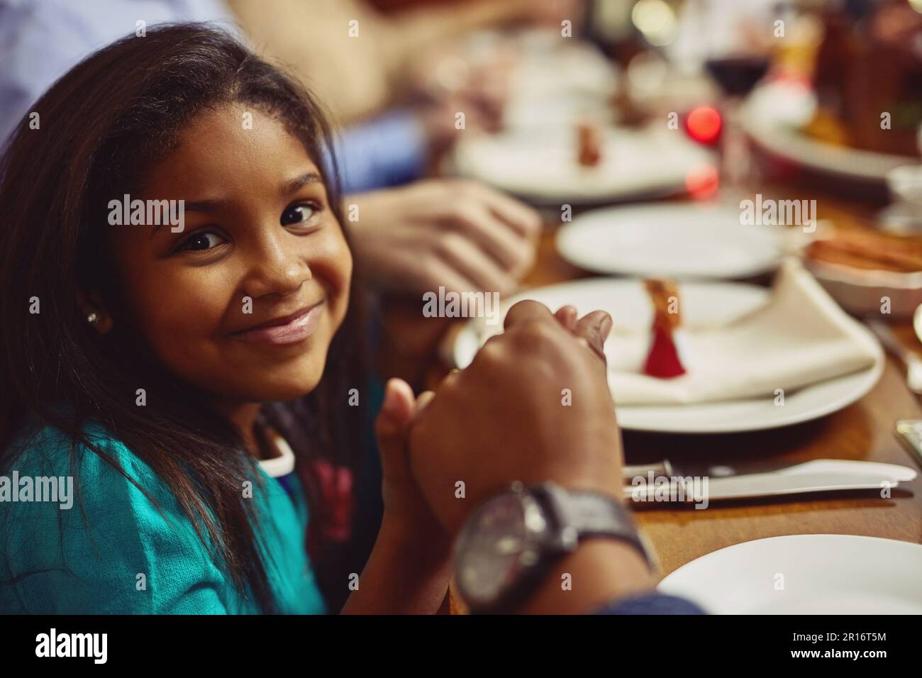 Portrait, meal and girl with her family, prayer and happiness with joy ...