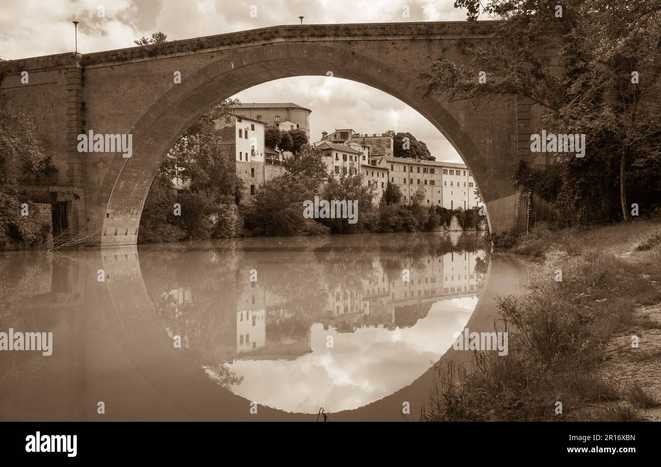 Sepia view of ancient Roman bridge over the river Metauro in ...