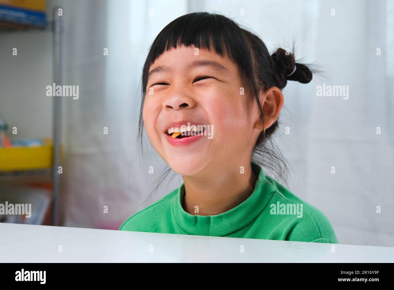 Happy cute little girl eating gelatin candy. Funny kid with chewing gum ...