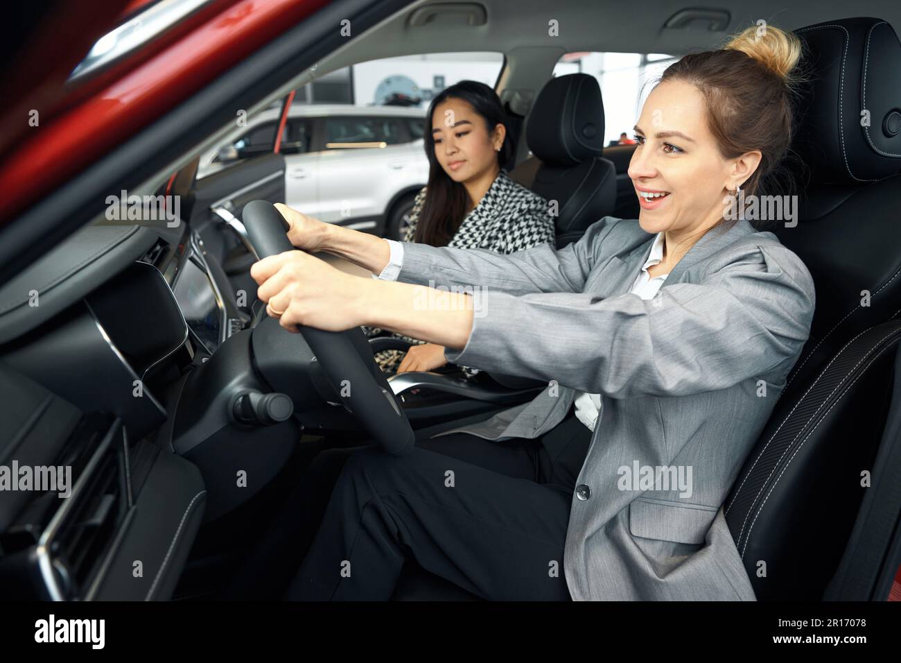 Two happy women sitting inside a car Stock Photo - Alamy