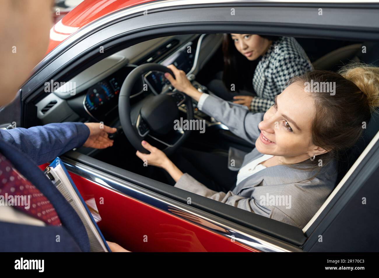 Driver and passanger women looking at someone from car Stock Photo - Alamy