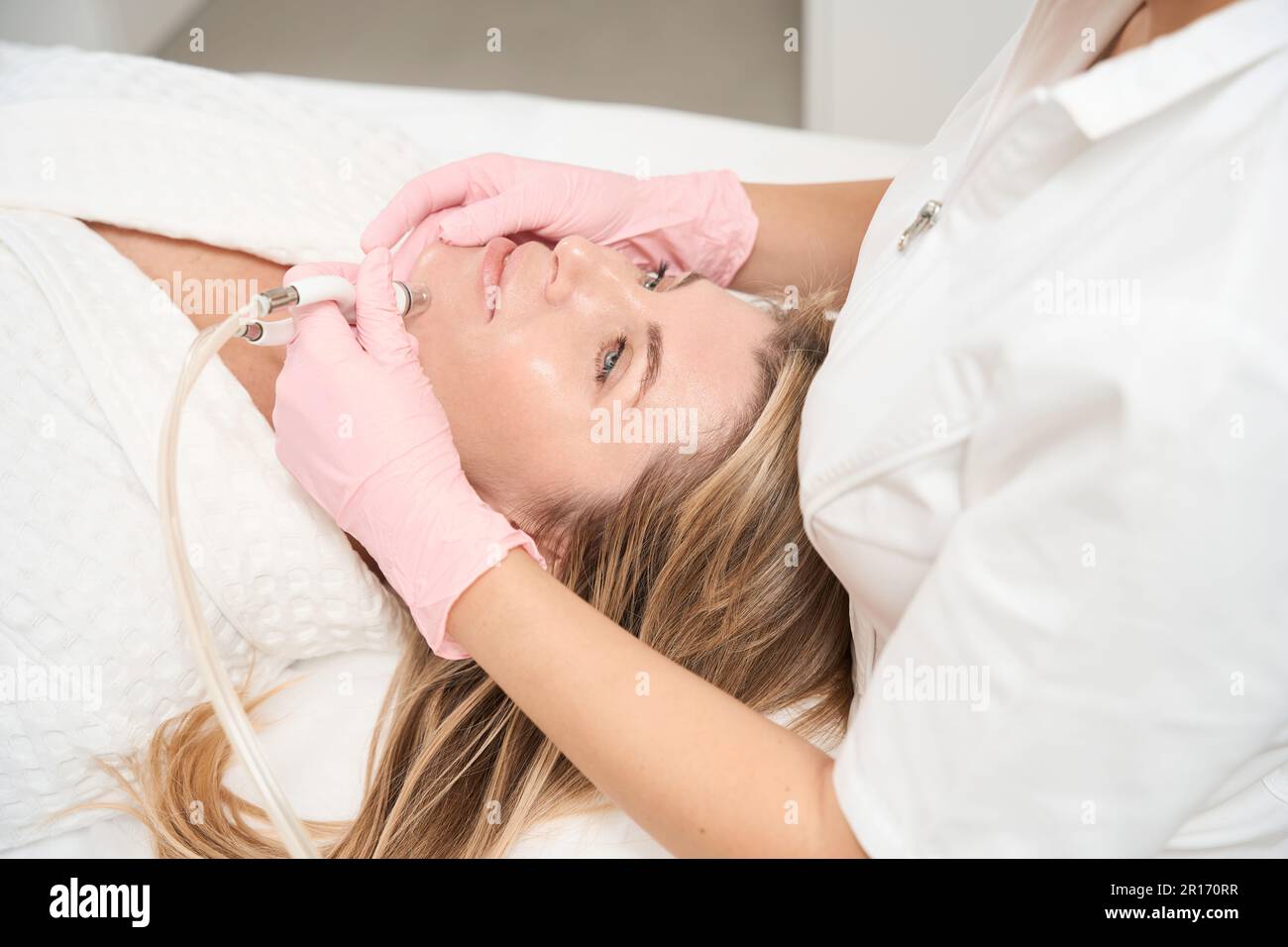 Female patient on rejuvenation procedure in aesthetic medicine clinic ...