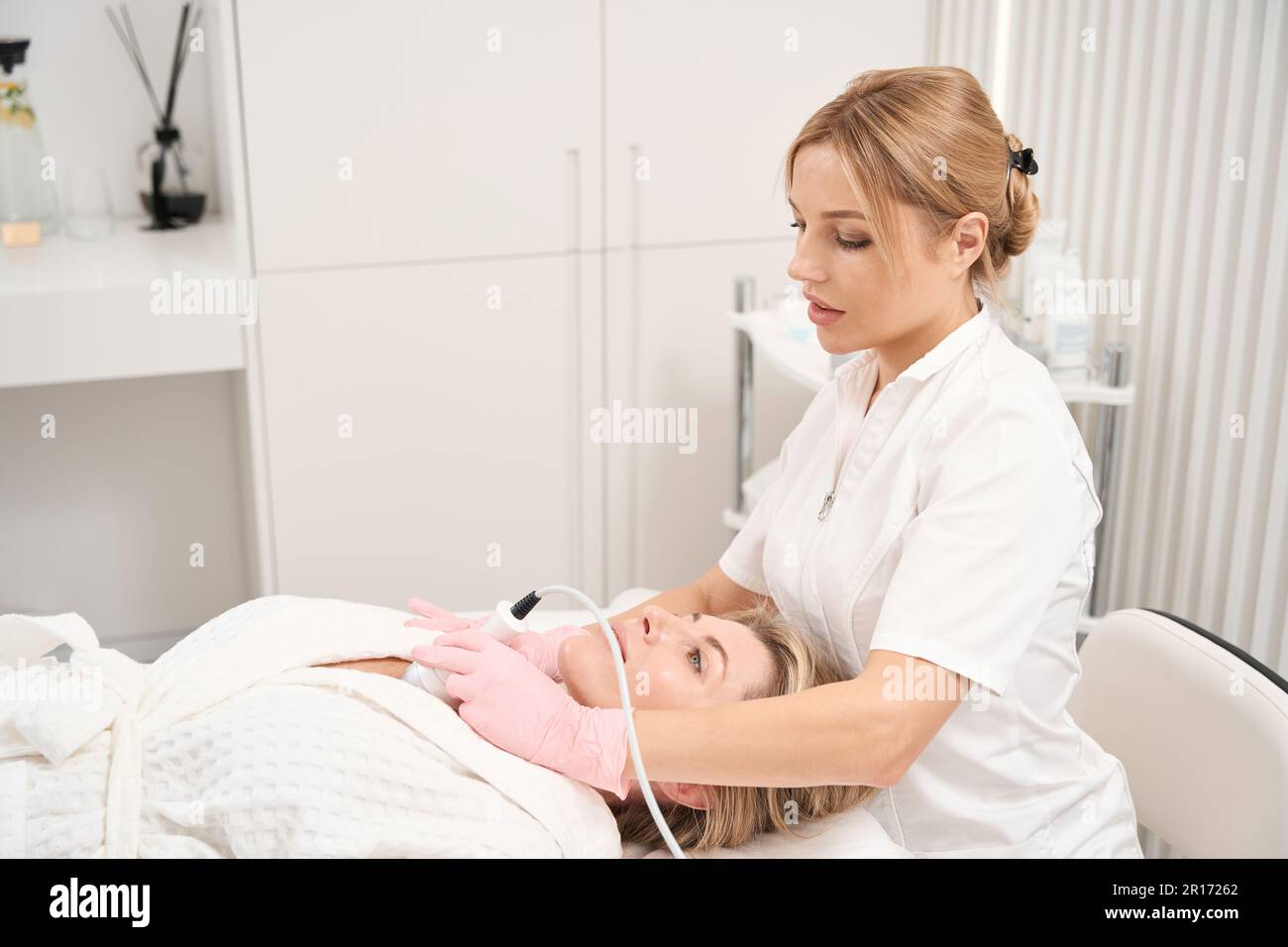Female cosmetologist works with the patient's decollete area Stock ...