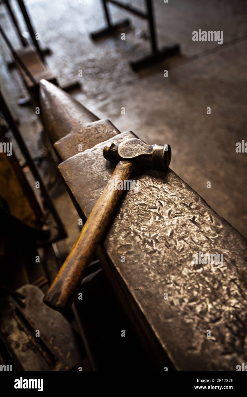 Hammer, anvil and blacksmith workplace in a iron factory and industrial ...