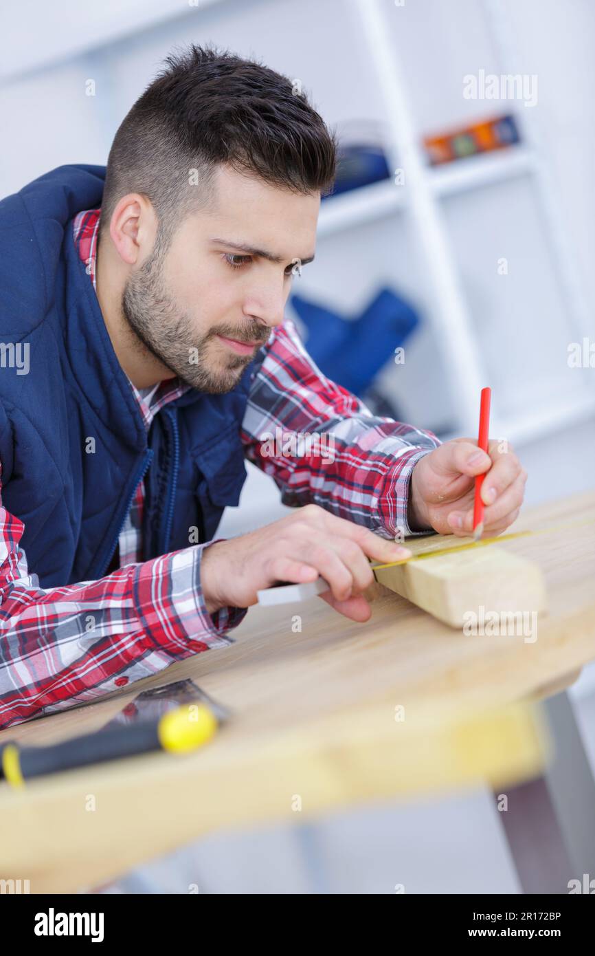 a carpenter marking the wood Stock Photo - Alamy
