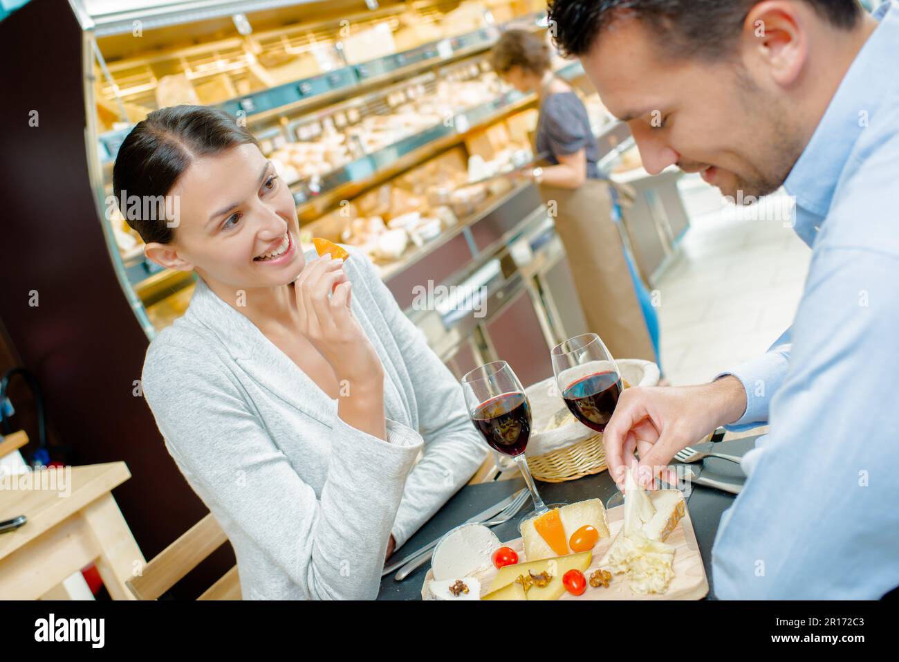 People eating cheese in a bakery Stock Photo - Alamy