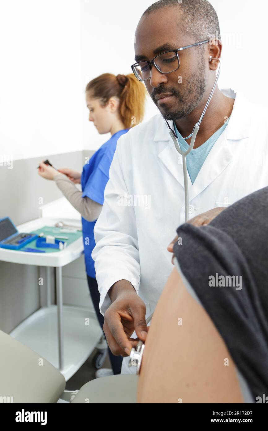 doctor listening to stethoscope held on patients back Stock Photo - Alamy