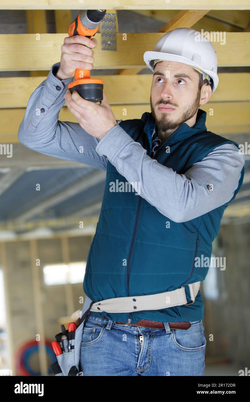 Young carpenter in uniform drilling hi-res stock photography and images ...