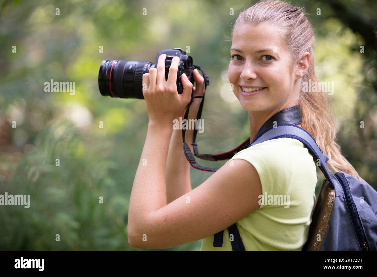 young woman photographer takes pictures in the wild Stock Photo - Alamy