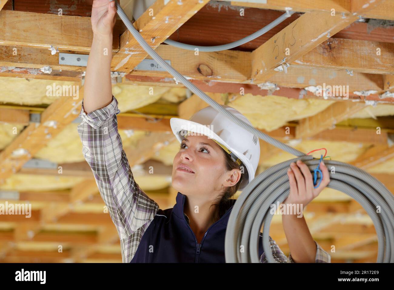 female plumber fixing pipe at construction site Stock Photo - Alamy