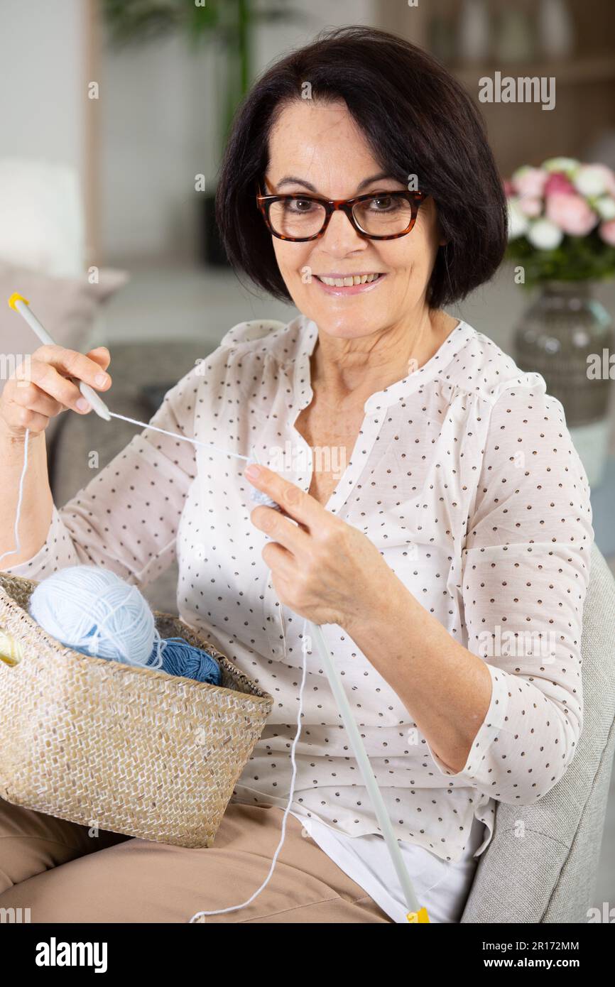 woman is doing some needle work Stock Photo - Alamy