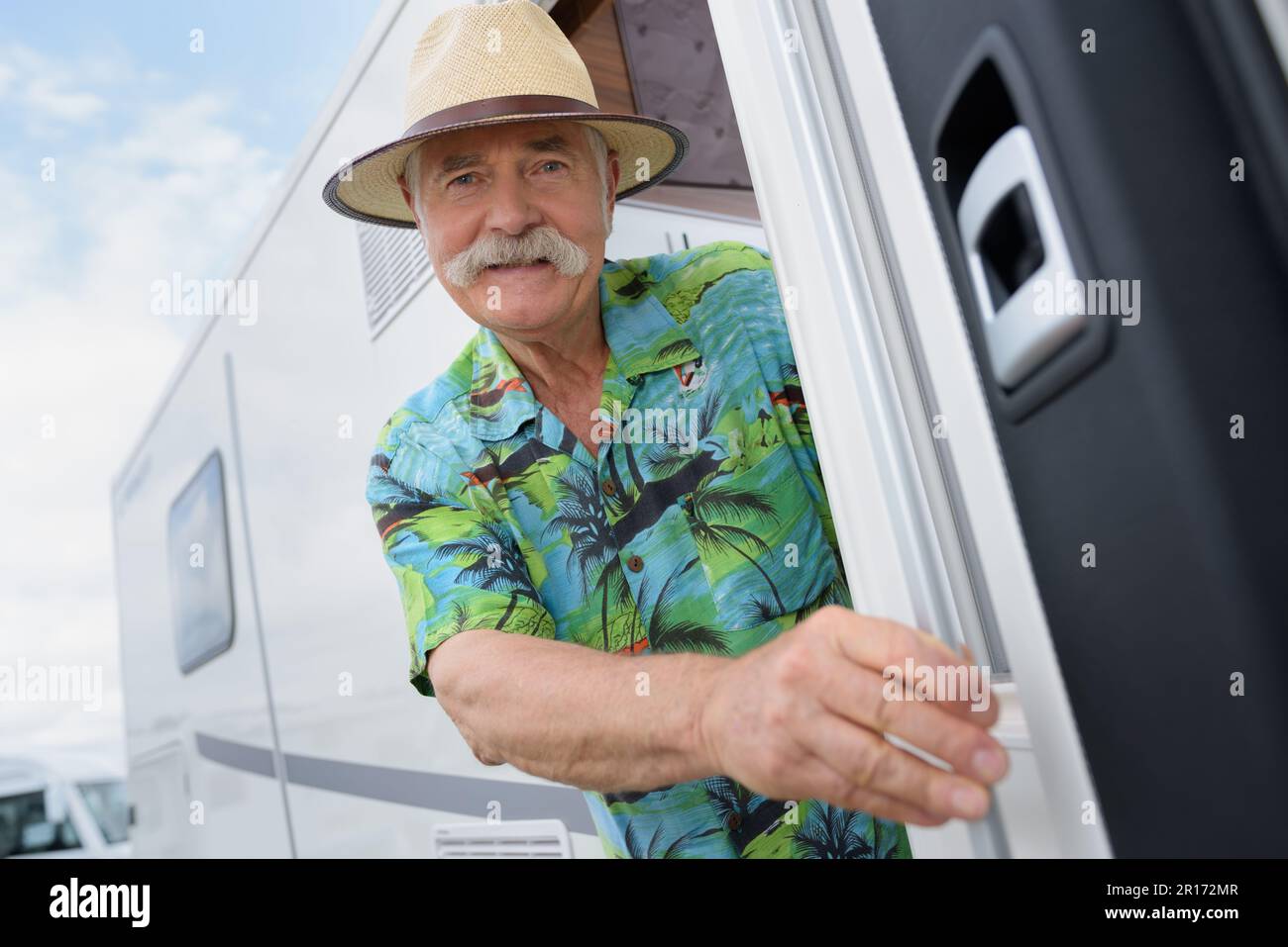 mature man next to camping car Stock Photo - Alamy