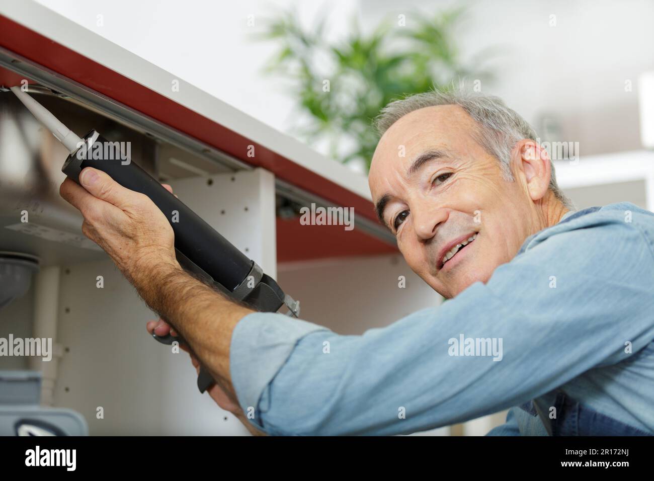 Handyman using caulking gun caulk hi-res stock photography and images ...