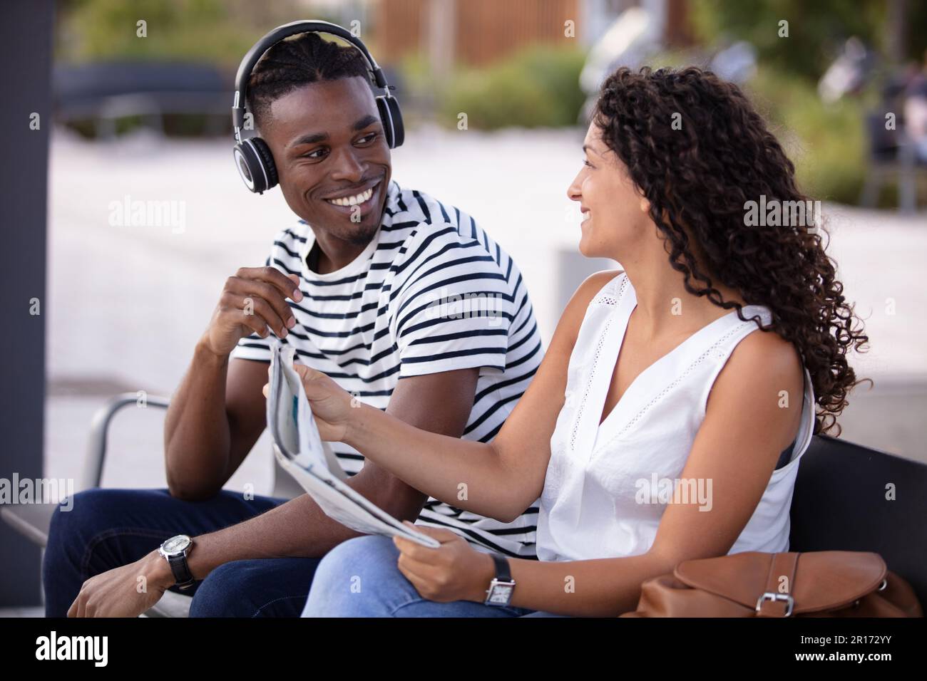 portrait of a couple flirting while waitin the bus outdoors Stock Photo ...