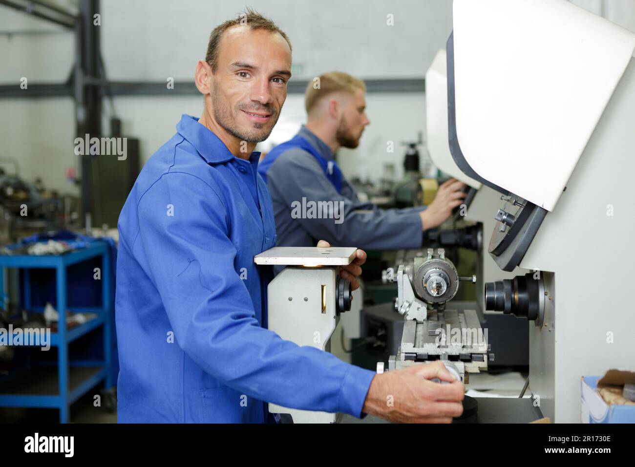 2 mechanic men try to fix and setup boat engine Stock Photo - Alamy