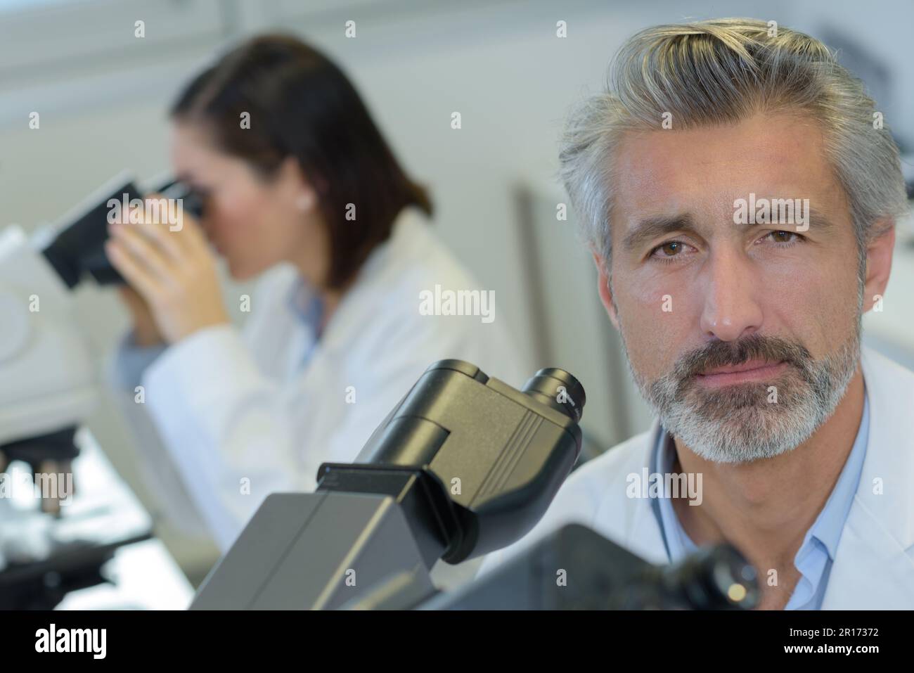 man with microscope in lab at university Stock Photo - Alamy