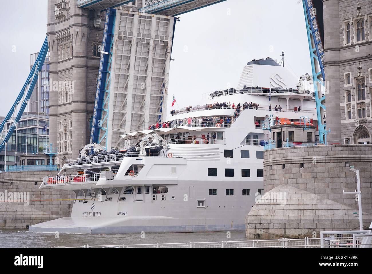 The Silversea Silver Wind cruise ship is guided through Tower Bridge in London, where it had ...